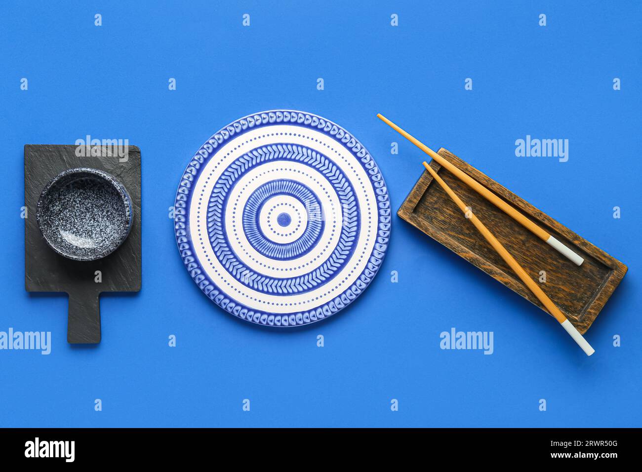 Chinese table setting on blue background Stock Photo - Alamy