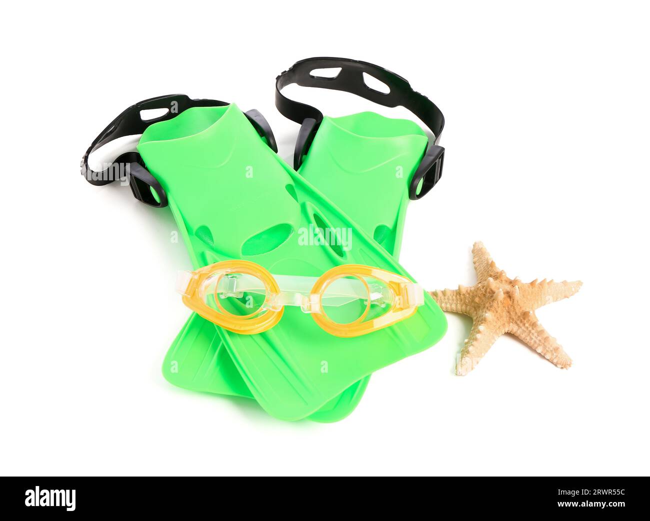 New swimming goggles, starfish and flippers on white background Stock ...