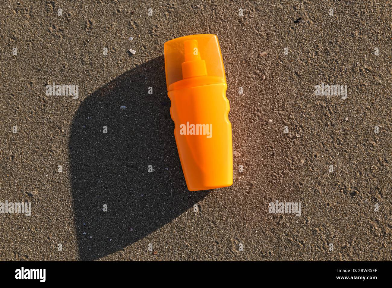 Bottle of sunscreen cream on sand at sea beach Stock Photo - Alamy