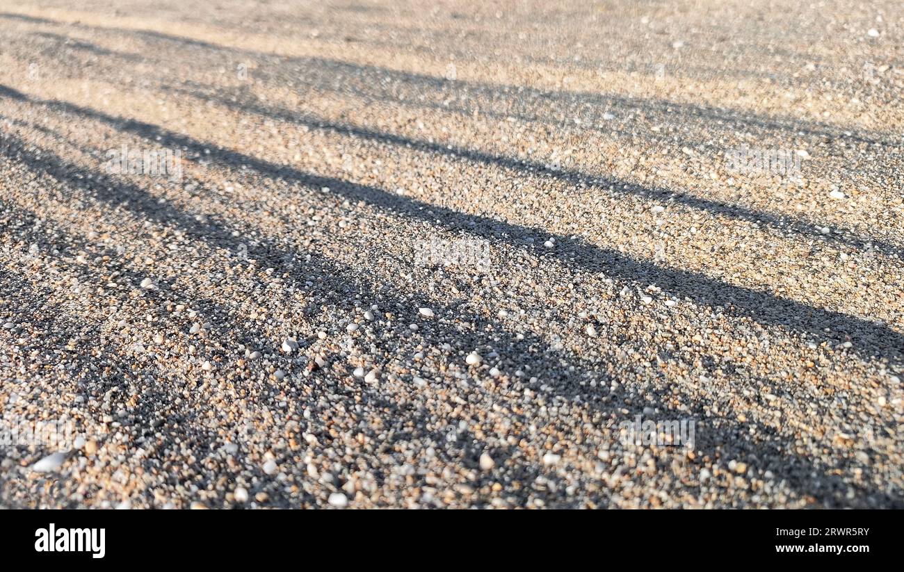 Textured sandy background with diagonal lines extending into horizon ...