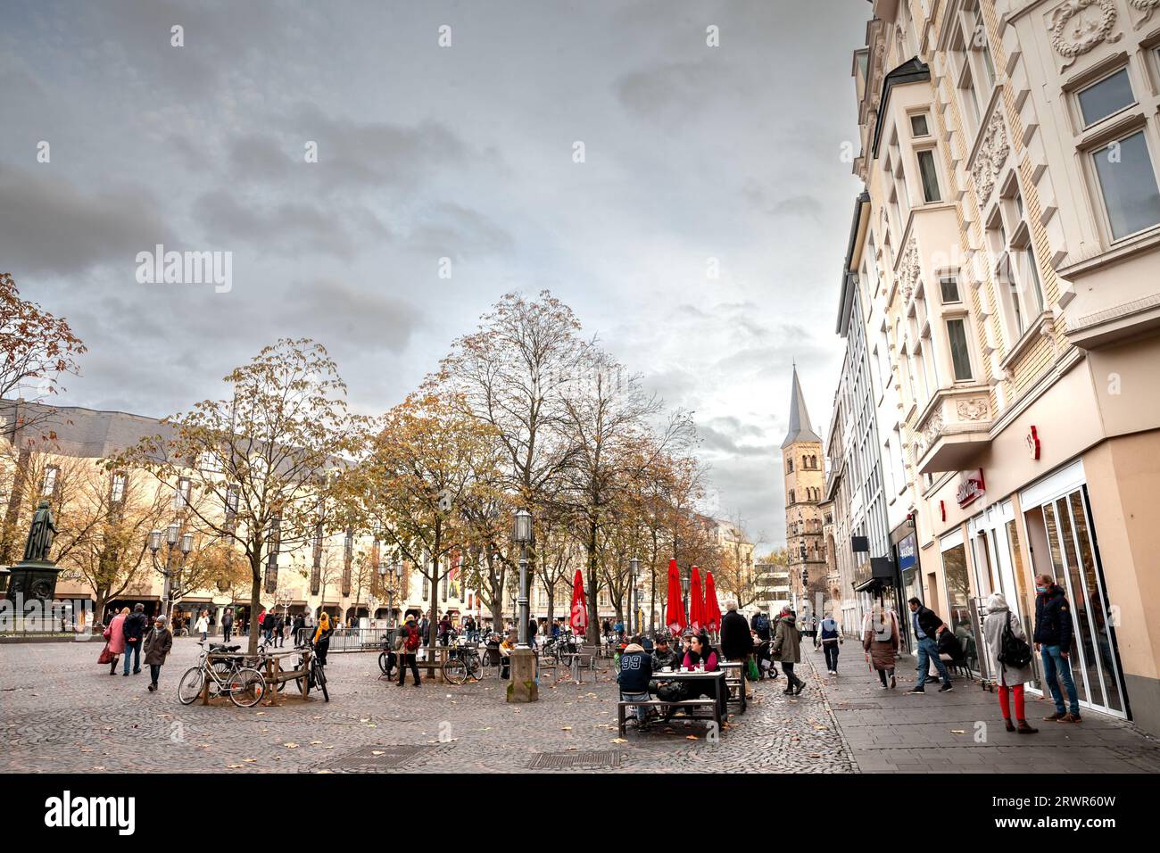 picture of the Munsterplatz street with germans walking by stores and ...