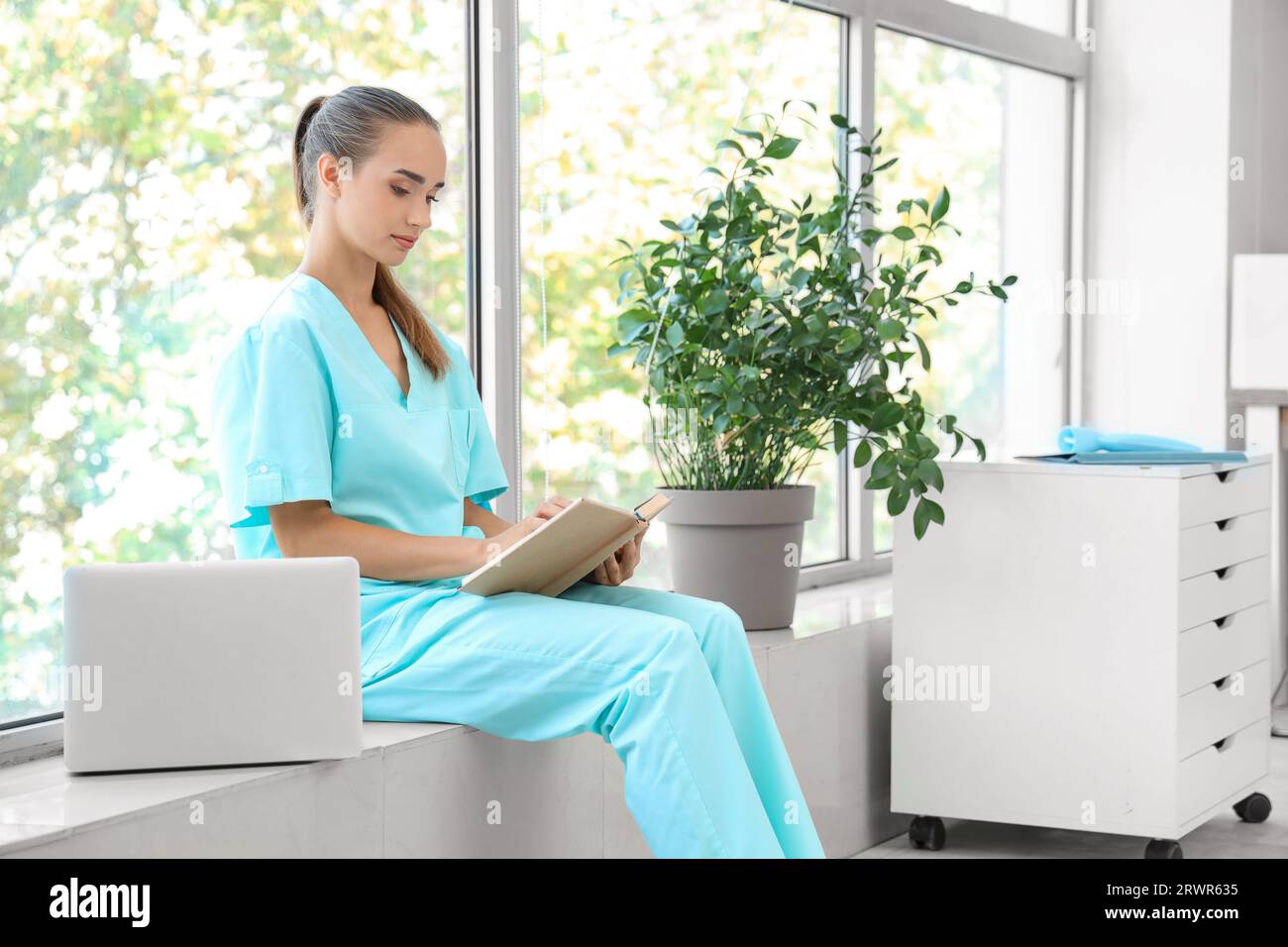 Female medical student reading book at university Stock Photo - Alamy