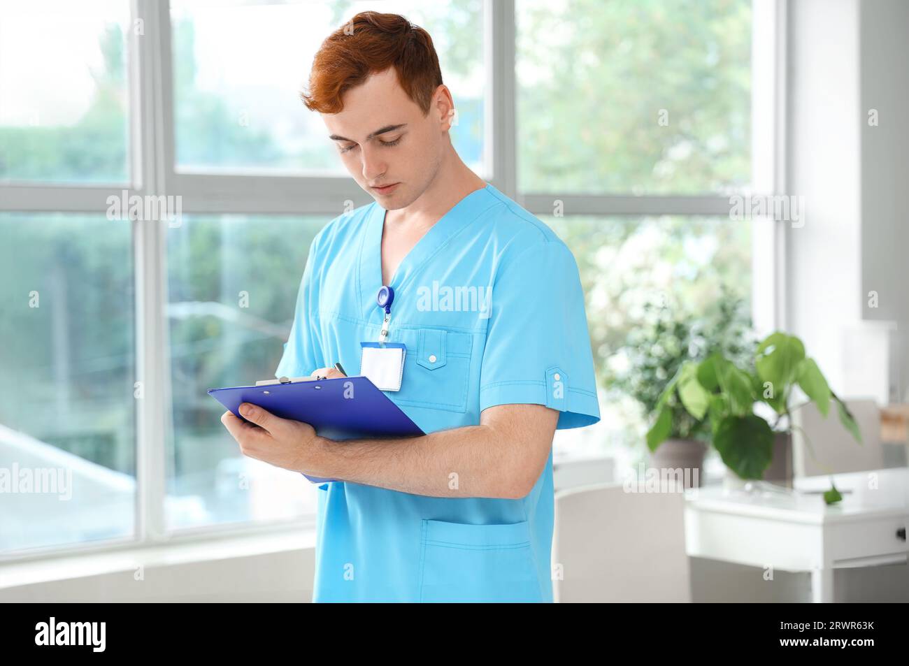 Male medical student with clipboard in clinic Stock Photo - Alamy