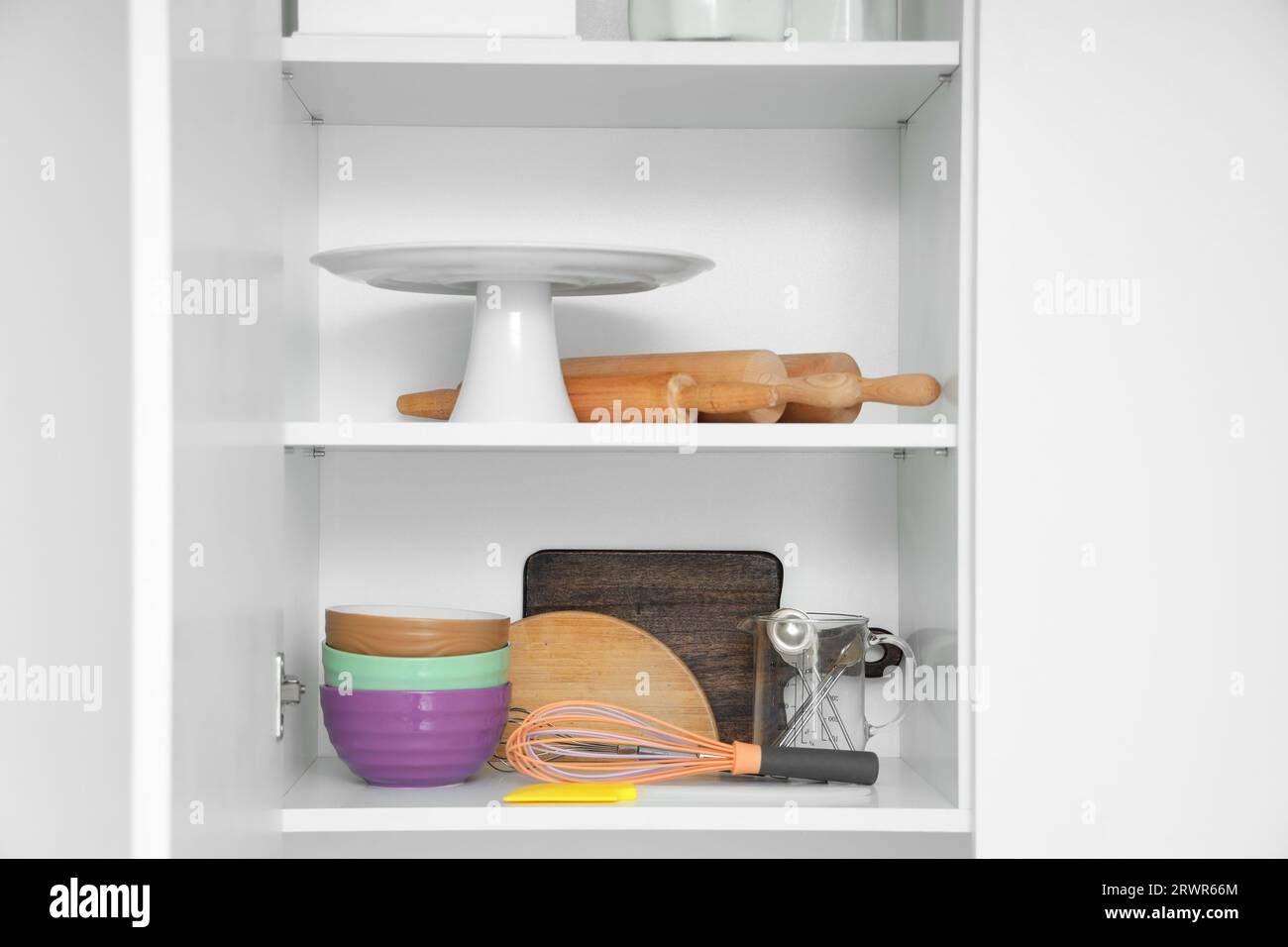 Cupboard with set of utensils for bakery in kitchen Stock Photo - Alamy