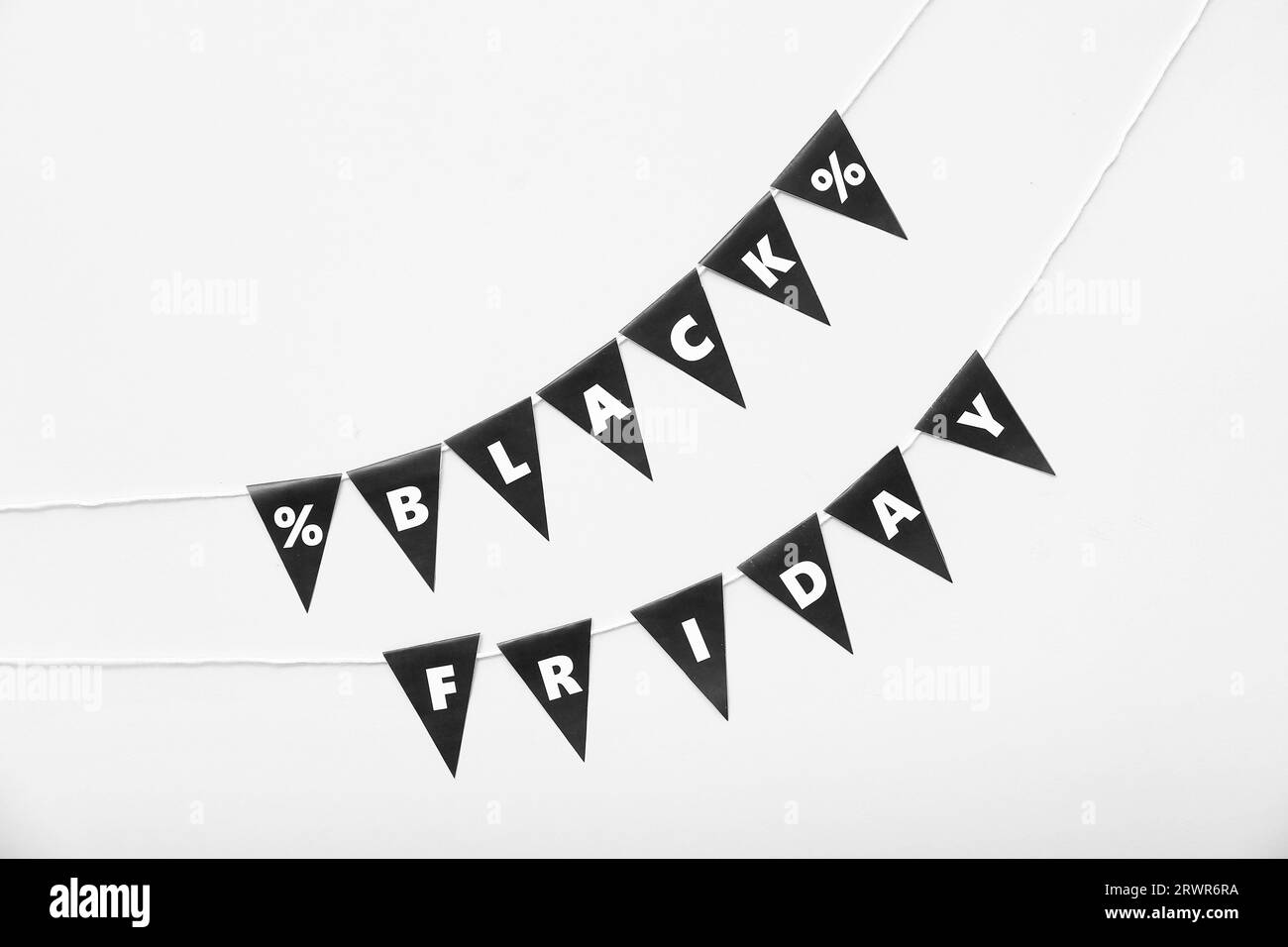 Rope, flags with text BLACK FRIDAY and percent signs on white ...