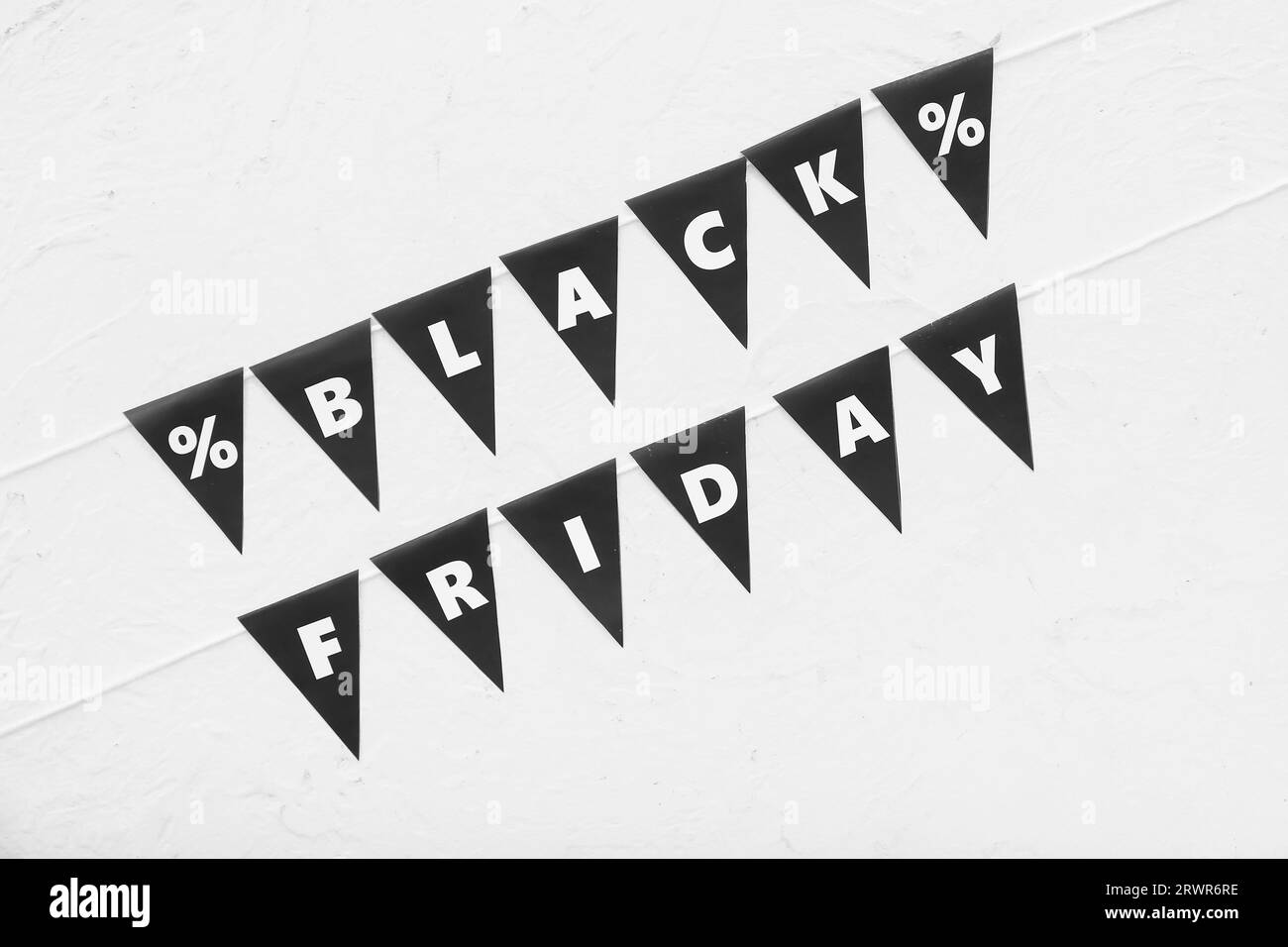 Rope, flags with text BLACK FRIDAY and percent signs on white ...
