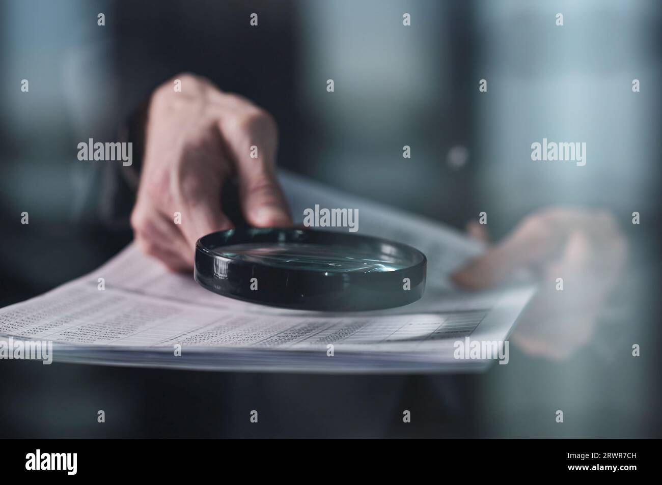 Businessman looking through a magnifying glass to contract Stock Photo ...