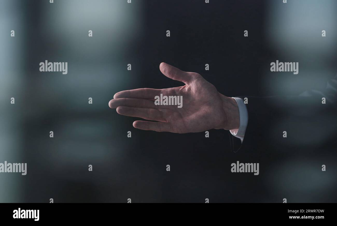 A man's hand is begging for something isolated on a black background ...