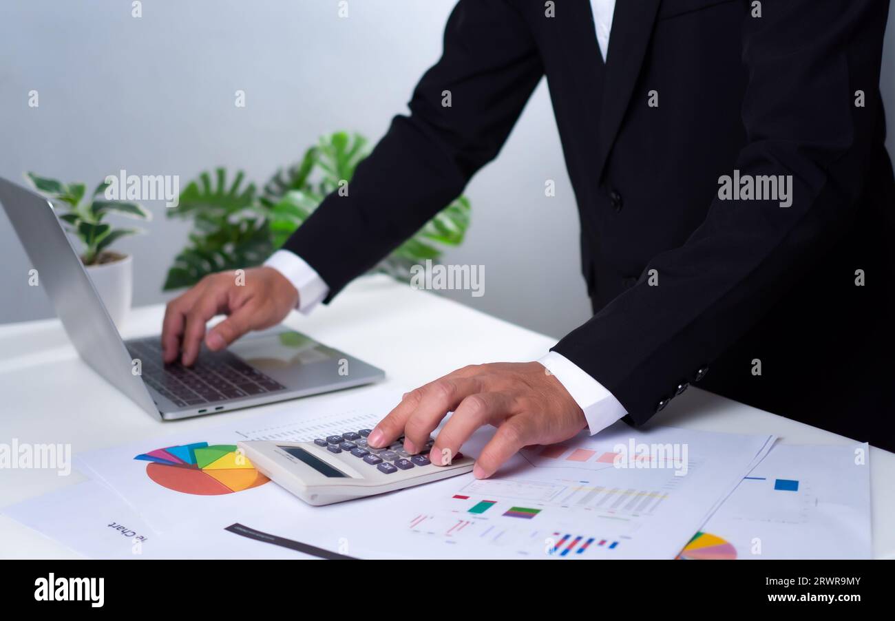 Business accounting concept. Business uses calculator with laptop ... Business accounting concept. Business uses calculator with laptop ...