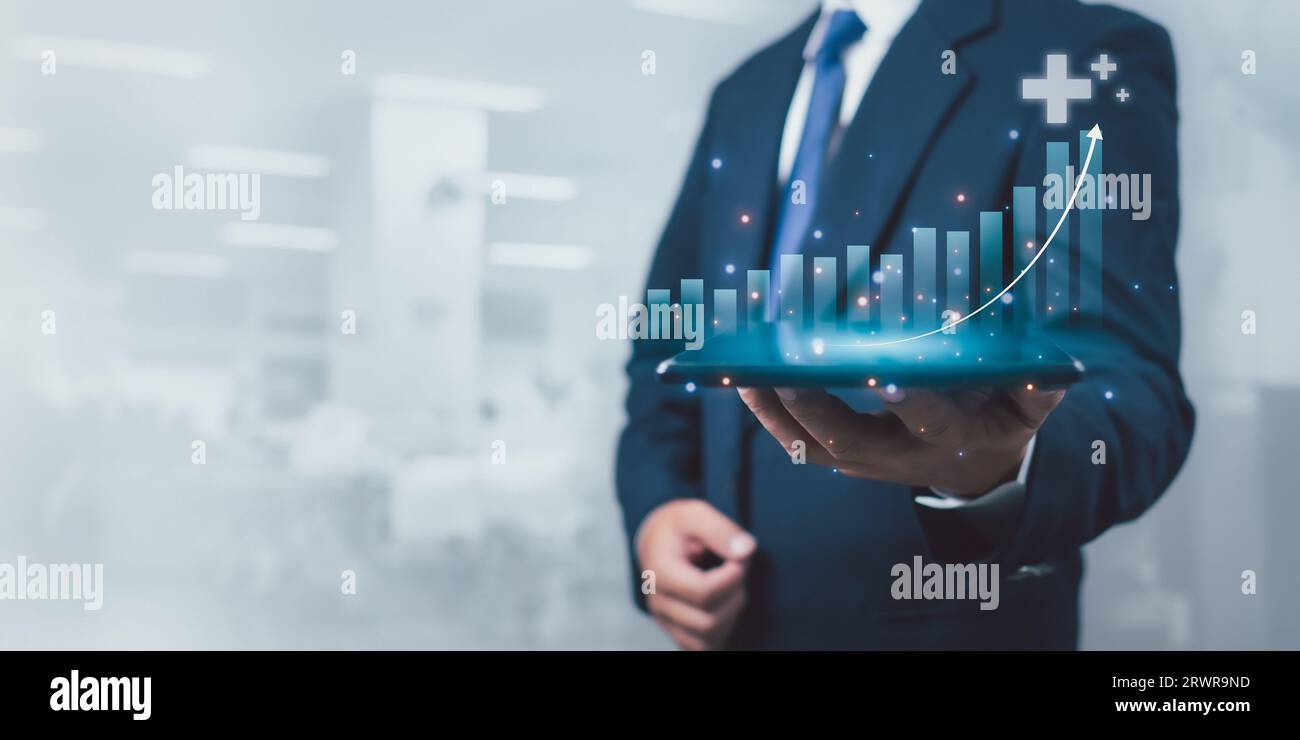 Businessman is holding a tablet to display a graph with percentage ...