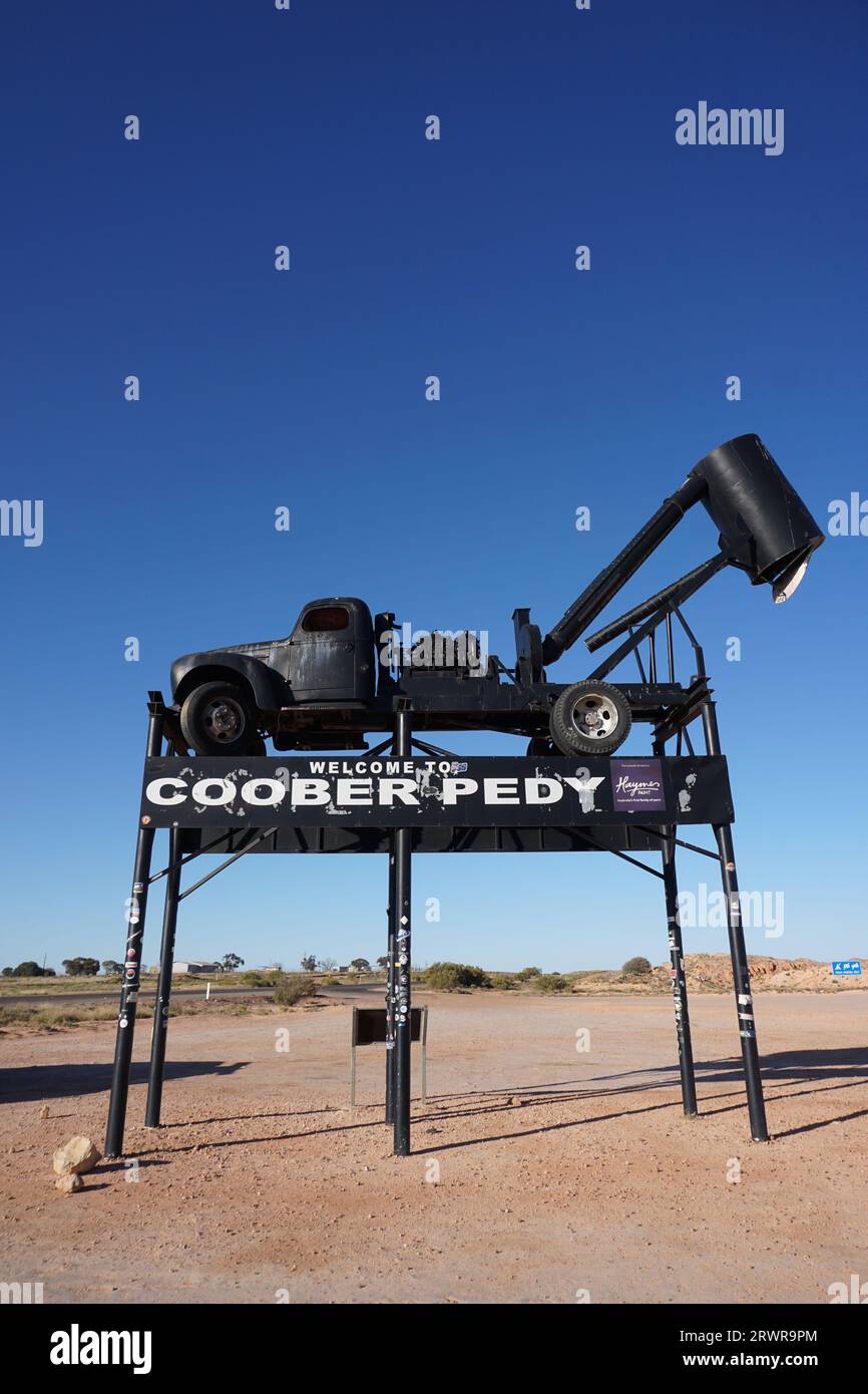 welcome sign covered in stickers with blower truck in opal mining ...