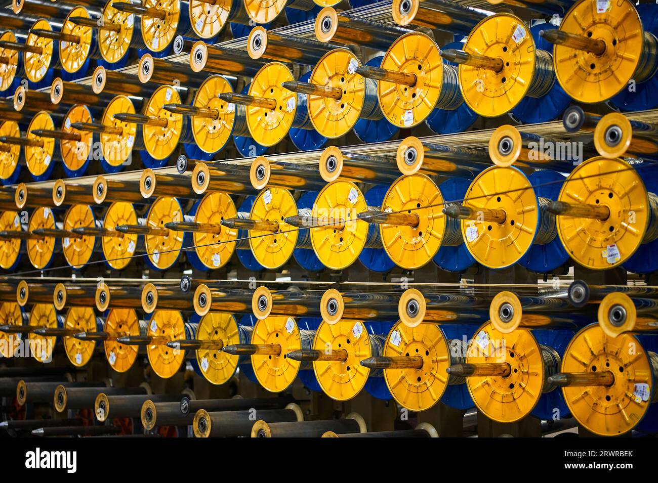 Bobbins coil thin wire to reinforce tires in plant workshop Stock Photo ...