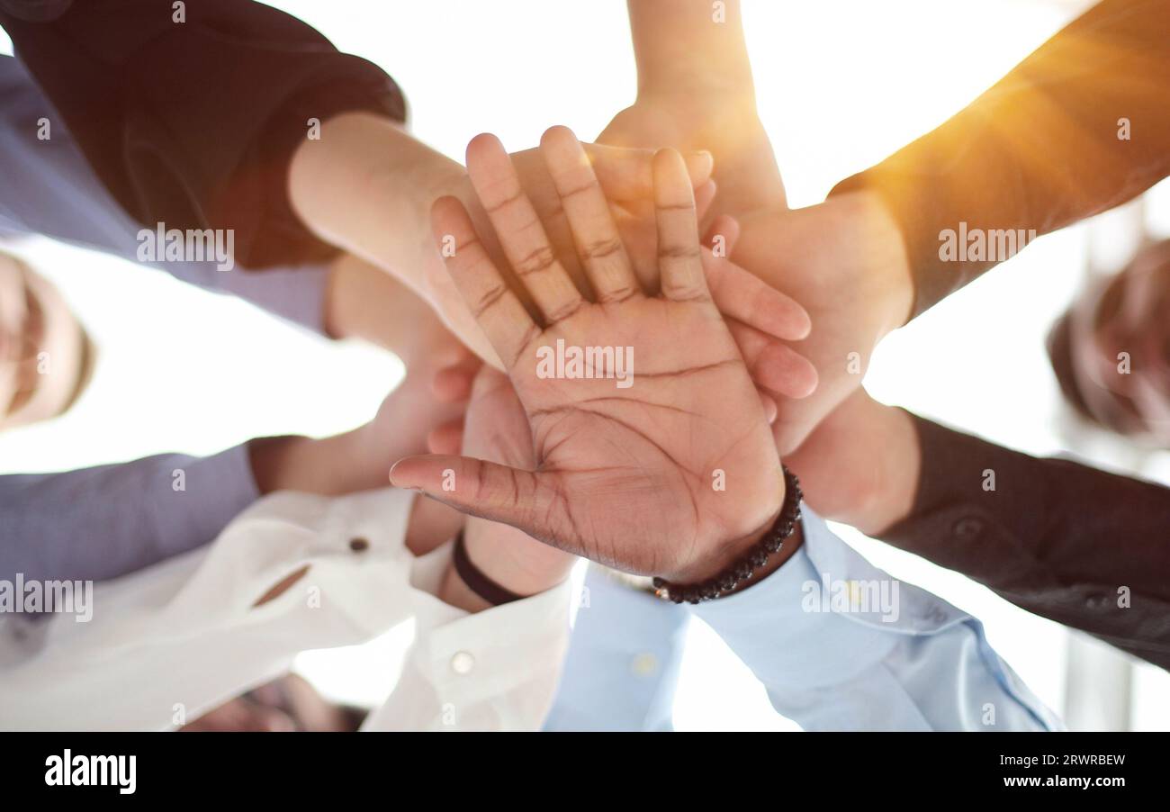Close up bottom view of people putting their hands together Stock Photo ...