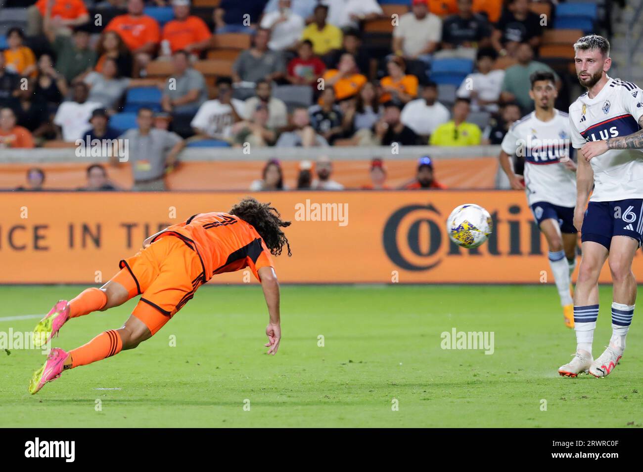 Houston Dynamo forward Ivan Franco, left, does a diving header to score ...
