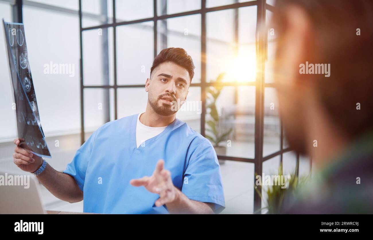 patient at a reception at the doctor looking an x-ray Stock Photo - Alamy