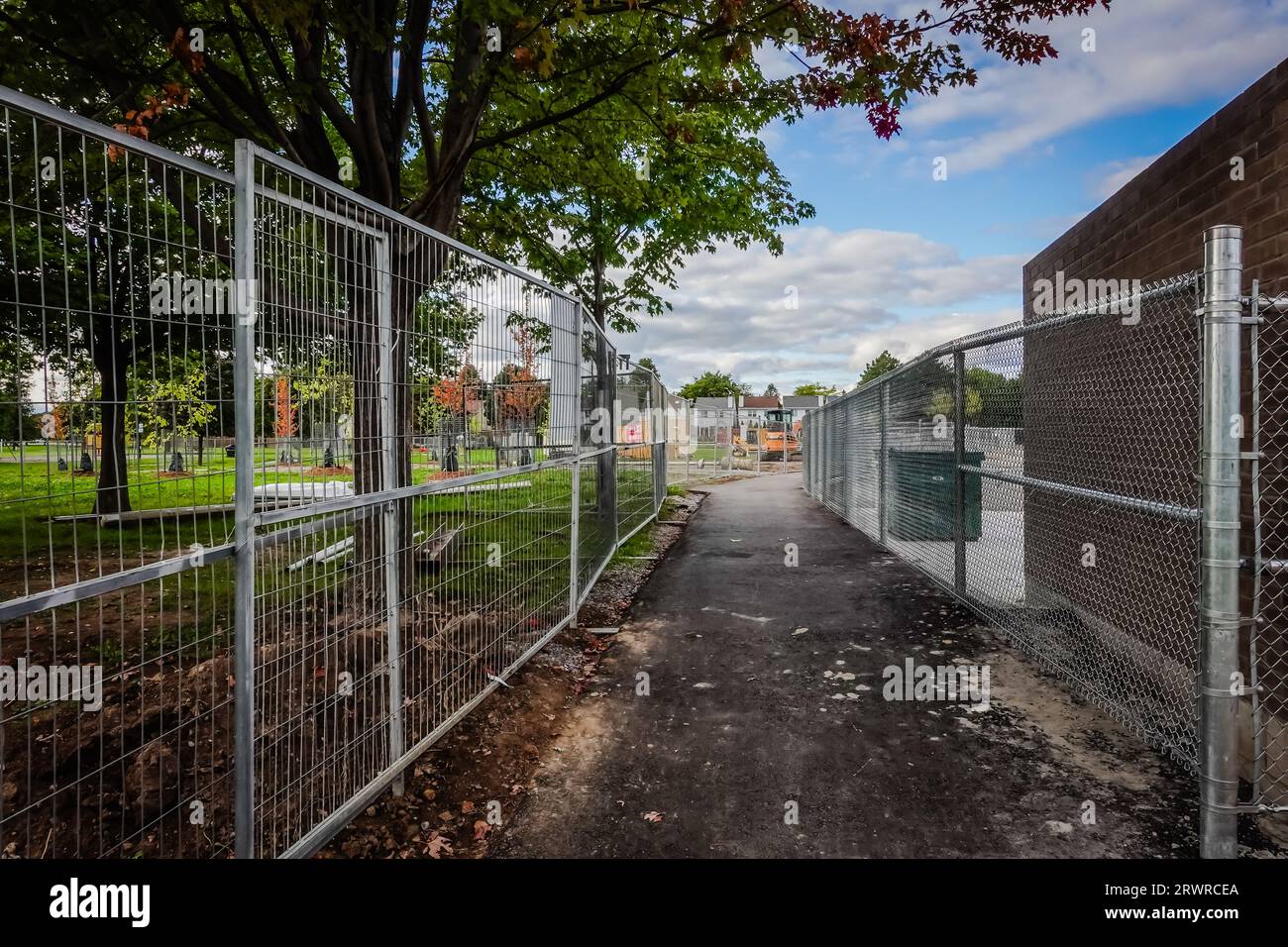a walking path with metal fences on both sides due to construction ...