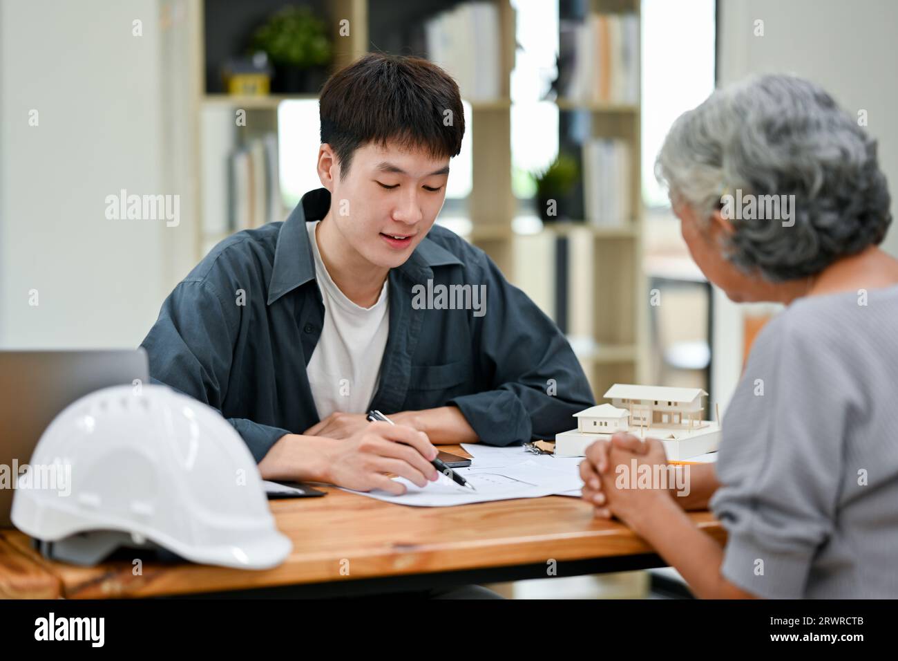 A professional Asian male engineer or architect is having a meeting ...