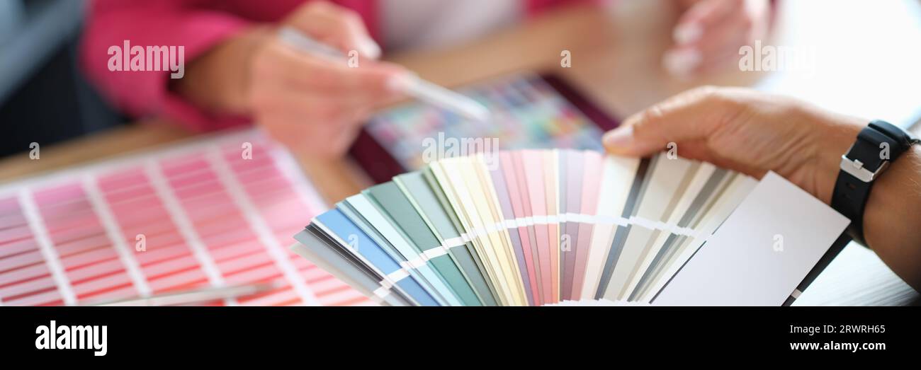 Designer and her client choosing colors for home renovation Stock Photo ...