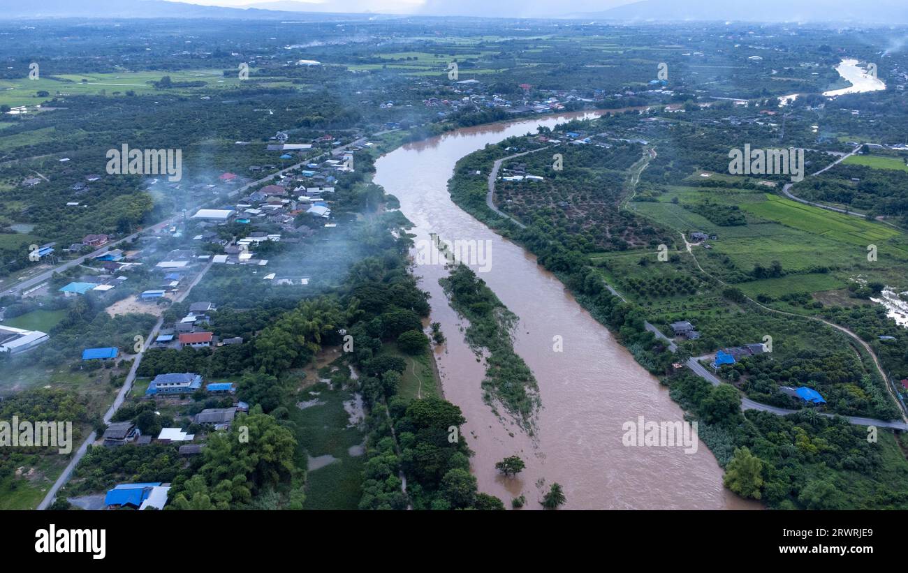 Aerial view of the Ping River across rice fields and rural villages ...