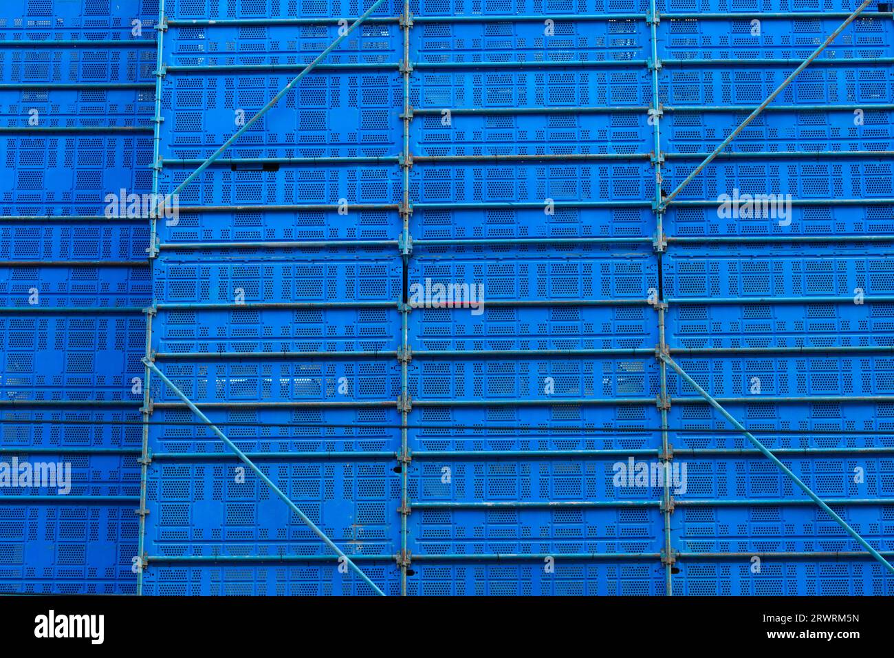Scaffolding blue colour showing abstract square patterns on building ...