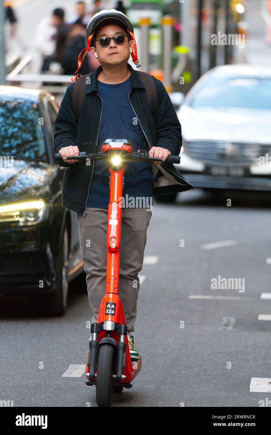 Electric scooter rider in city commute and travel on shared lane in ...