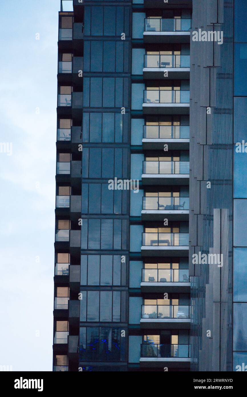 Modern city building apartment block with small balconies, glass ...