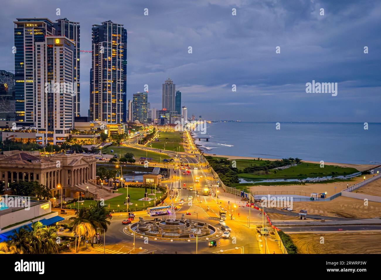 An urban waterfront street scene with modern high-rise buildings in ...