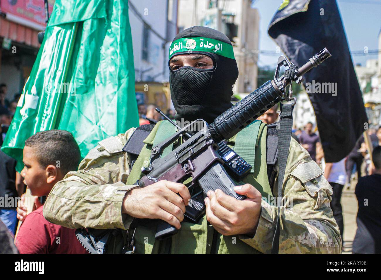 A masked gunman takes part in the funeral of Mahmoud al-Sadi, 23 years ...