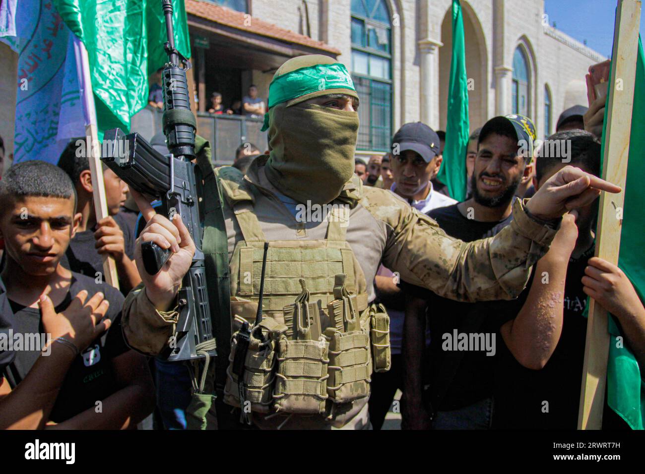 A masked gunman takes part in the funeral of Mahmoud al-Sadi, 23 years ...