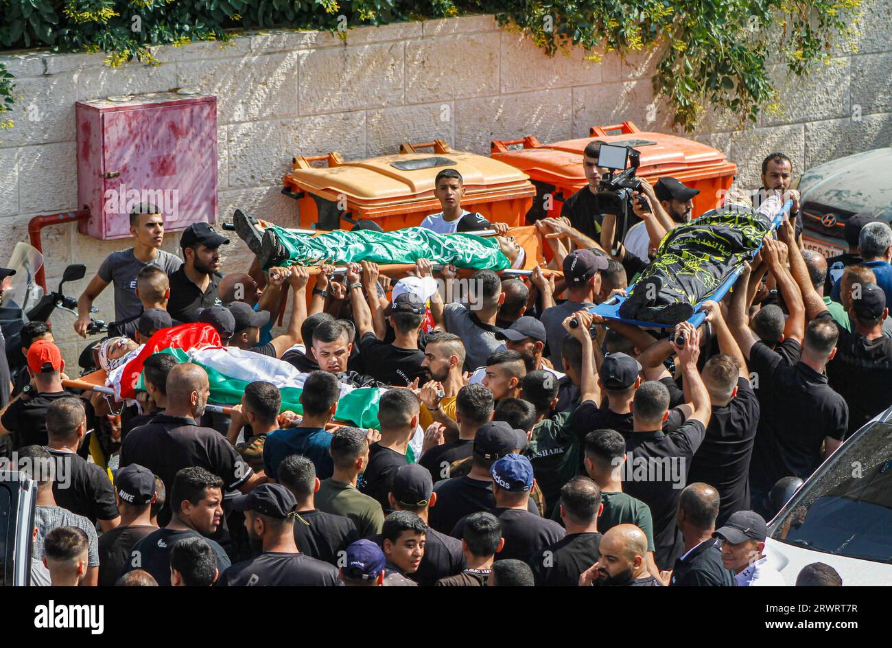 (EDITOR'S NOTE: Image depicts death) Mourners carry the bodies of ...