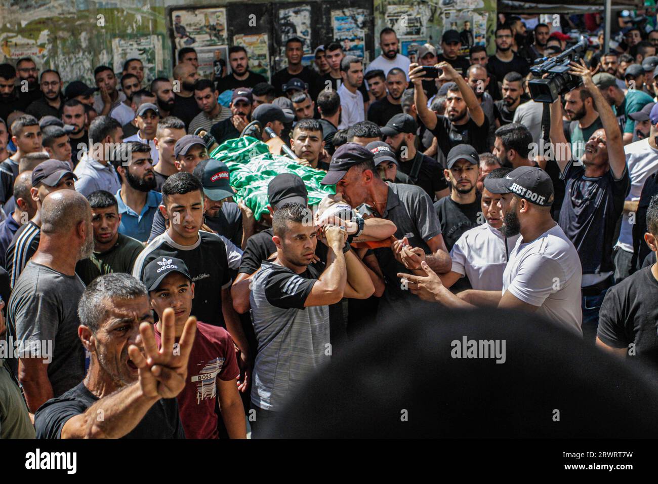 (EDITOR'S NOTE: Image depicts death) Mourners carry one of the dead ...