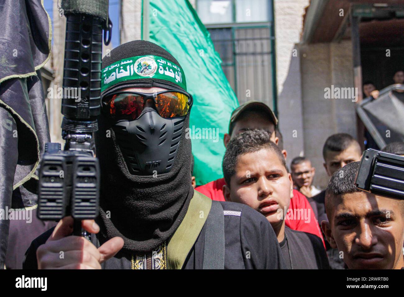 A masked gunman takes part in the funeral of Mahmoud al-Sadi, 23 years ...