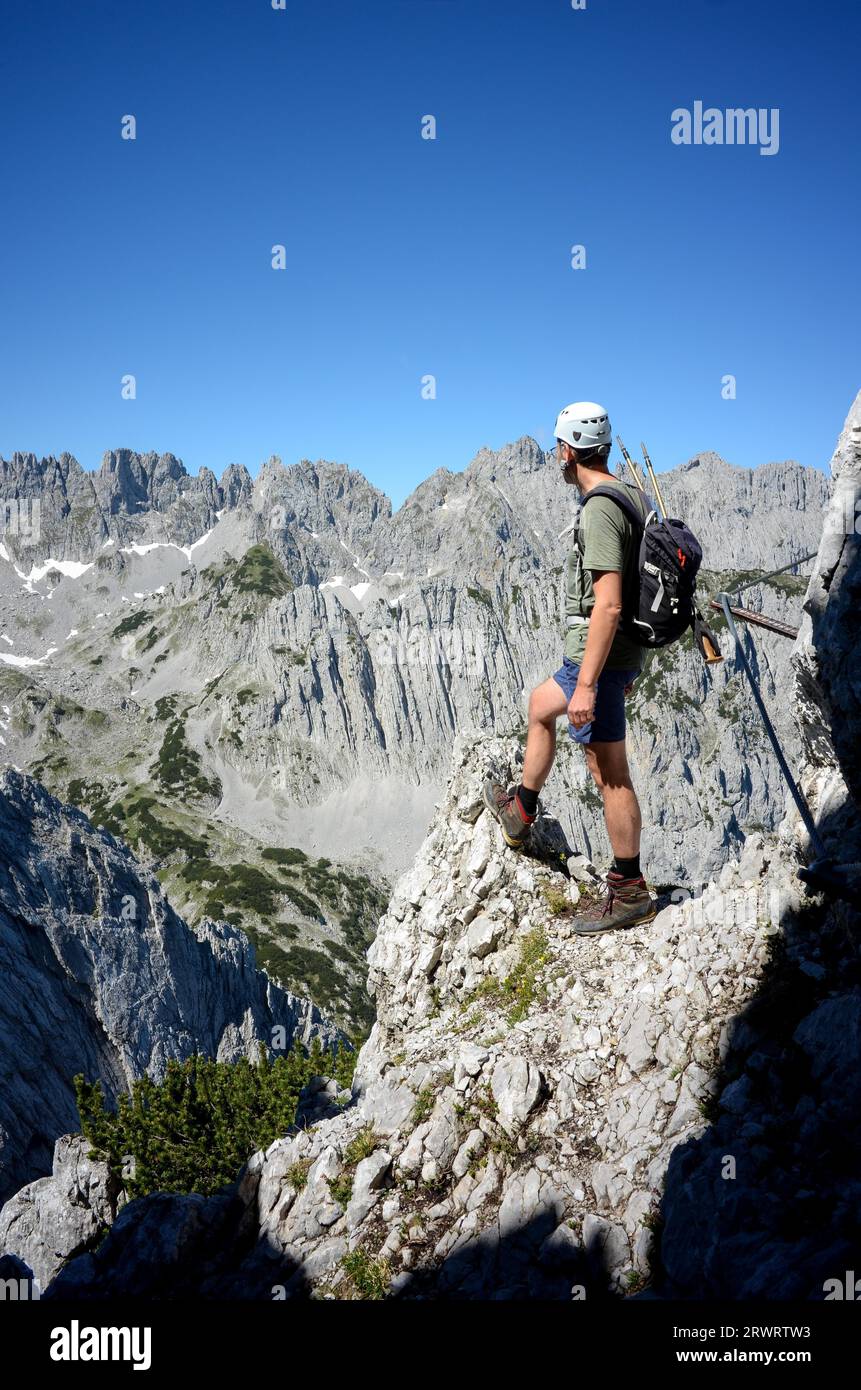 Climber on via ferrata enjoying the view of the Wilder Kaiser on the ...