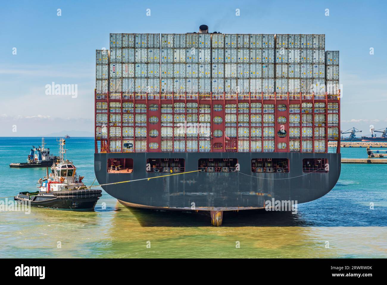 Container ship with tugboats in the harbour Stock Photo - Alamy