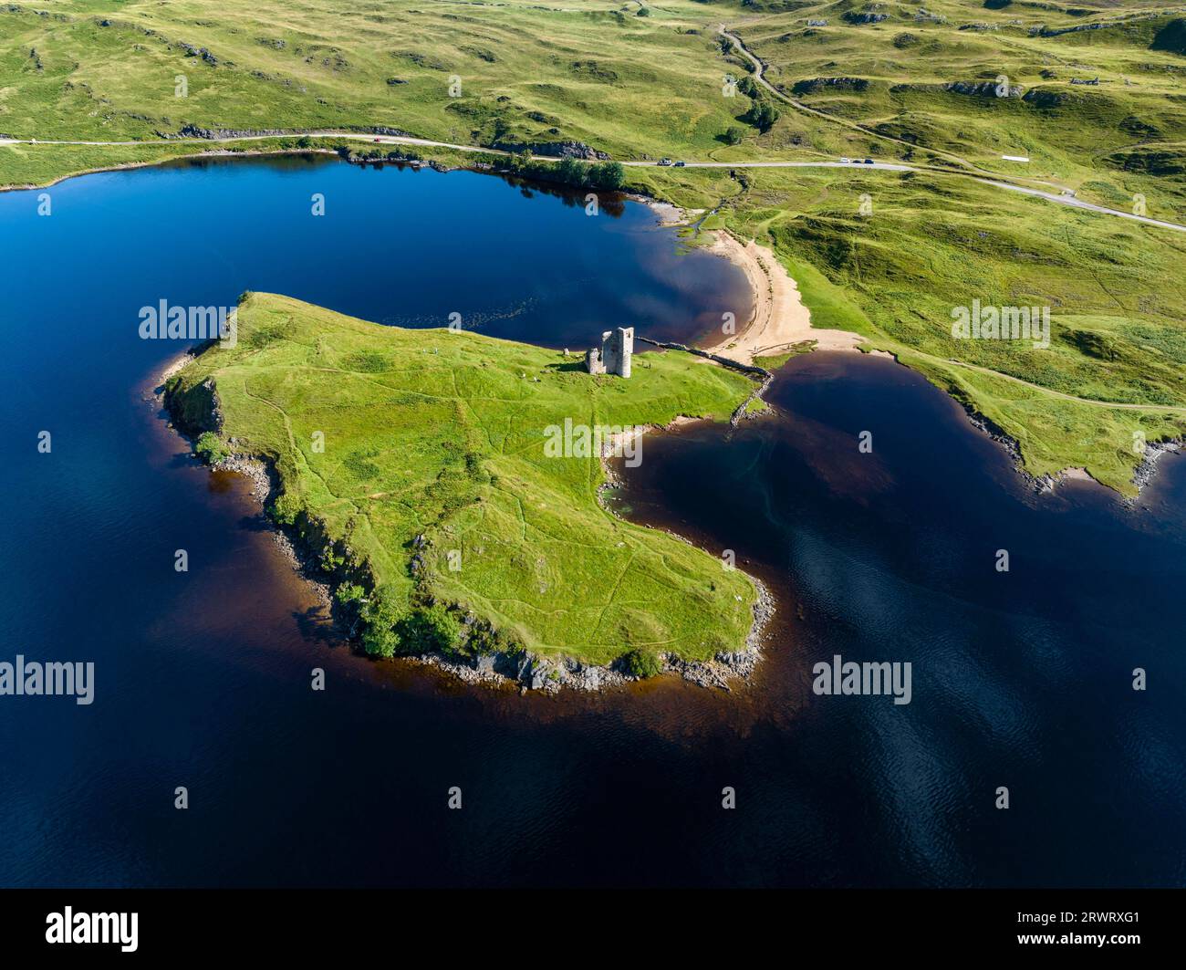 Aerial view of the freshwater loch Loch Assynt with the ruins of ...