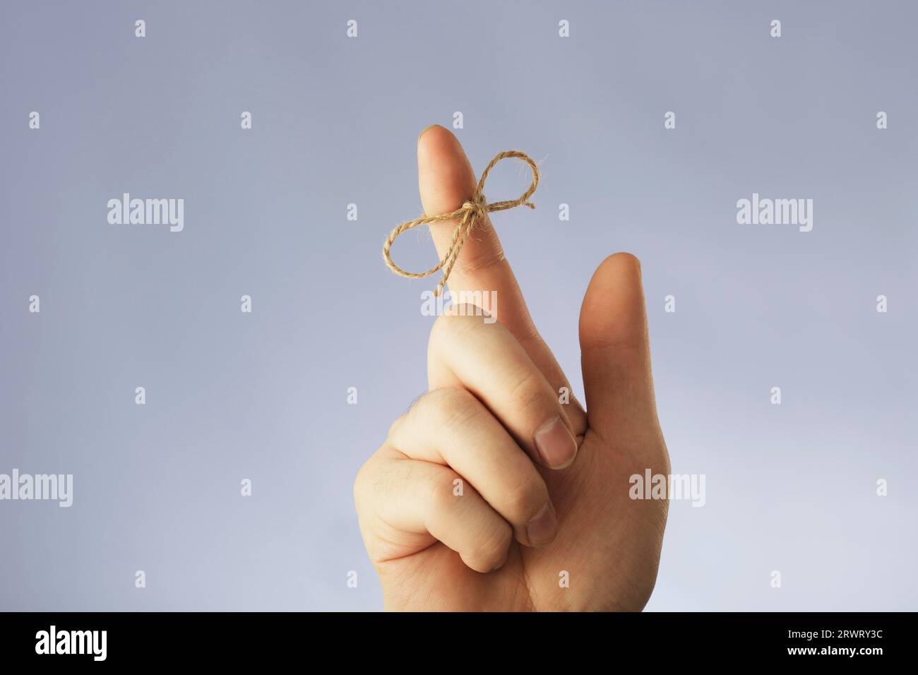 A string tied around an index finger Stock Photo - Alamy