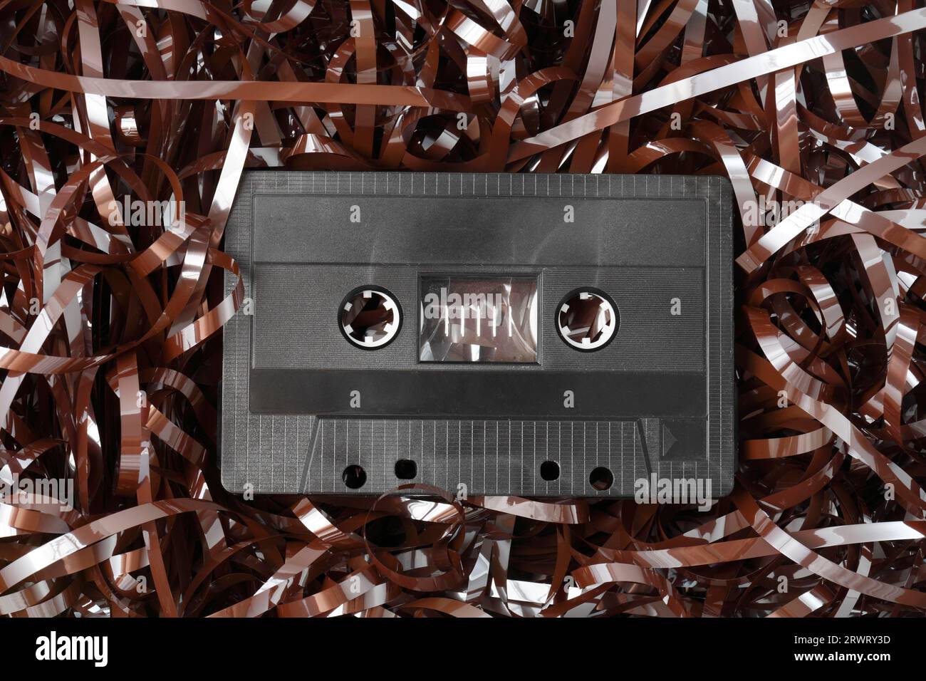 Old black audio C-cassette and tangled tape Stock Photo - Alamy