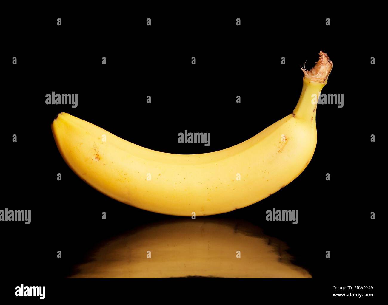 A Banana on black reflective surface. The reflection is real, no ...