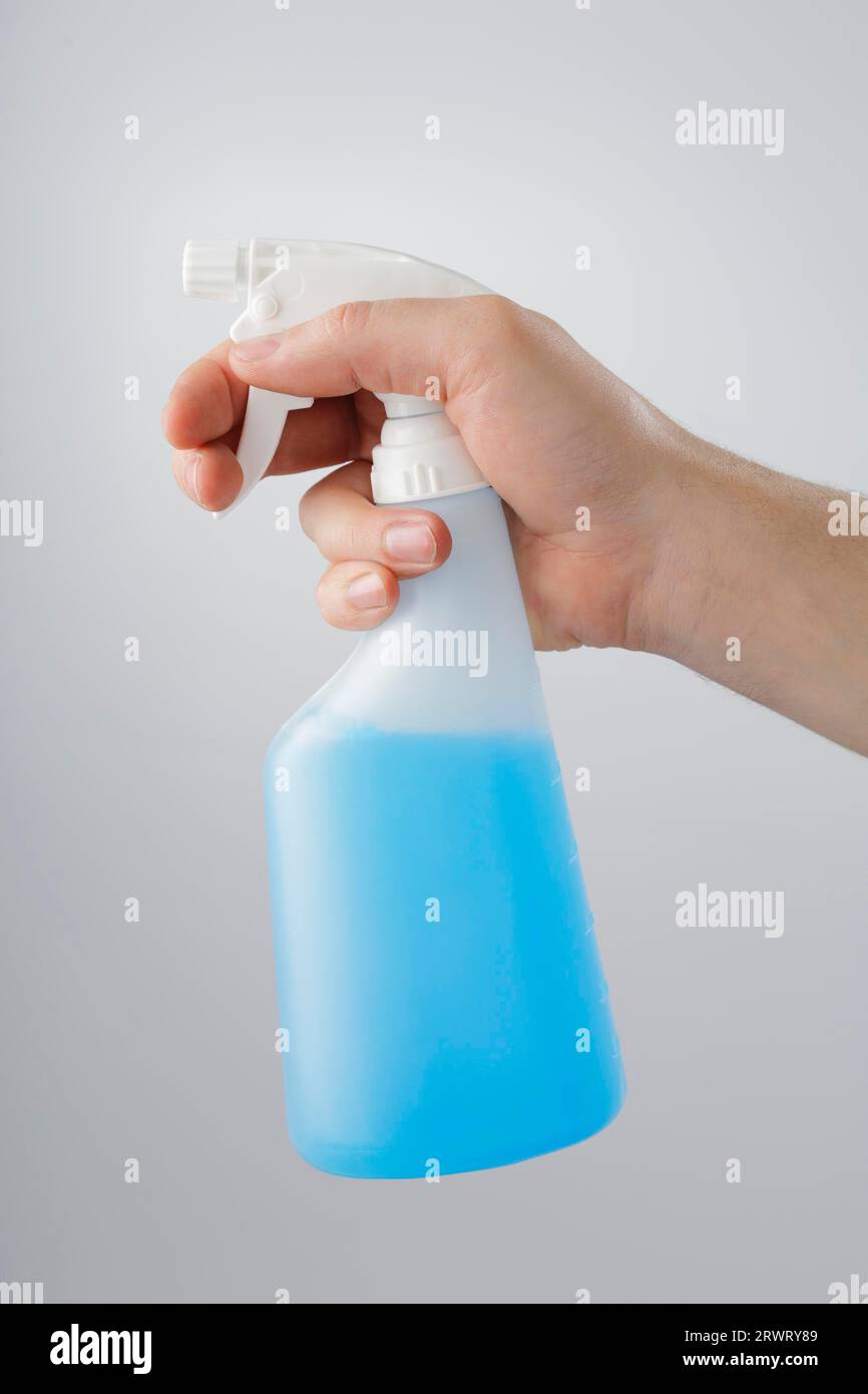 A Hand holding a spray bottle Stock Photo - Alamy