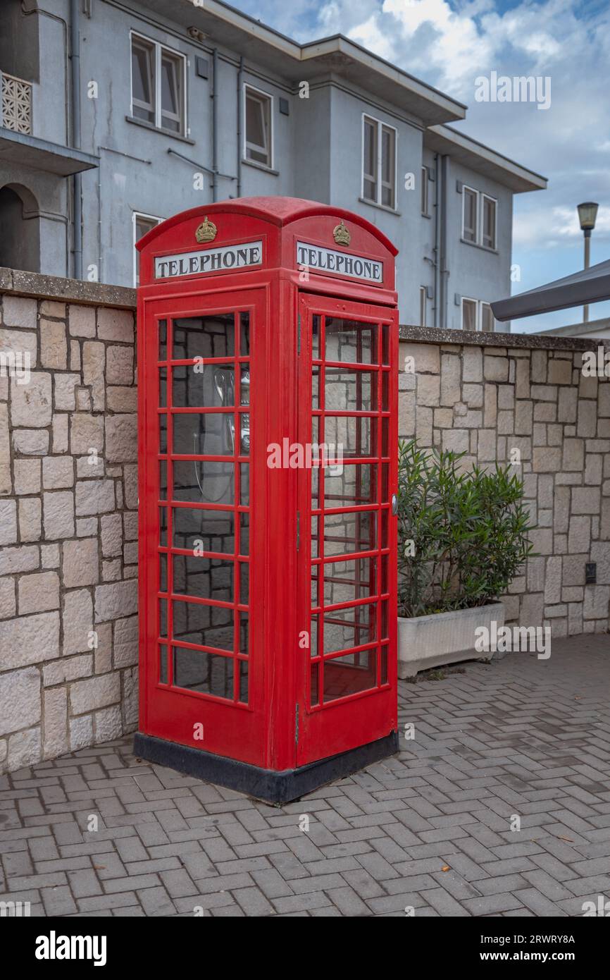 Gibraltar cityscape. Close up of empty typical English red telephone ...