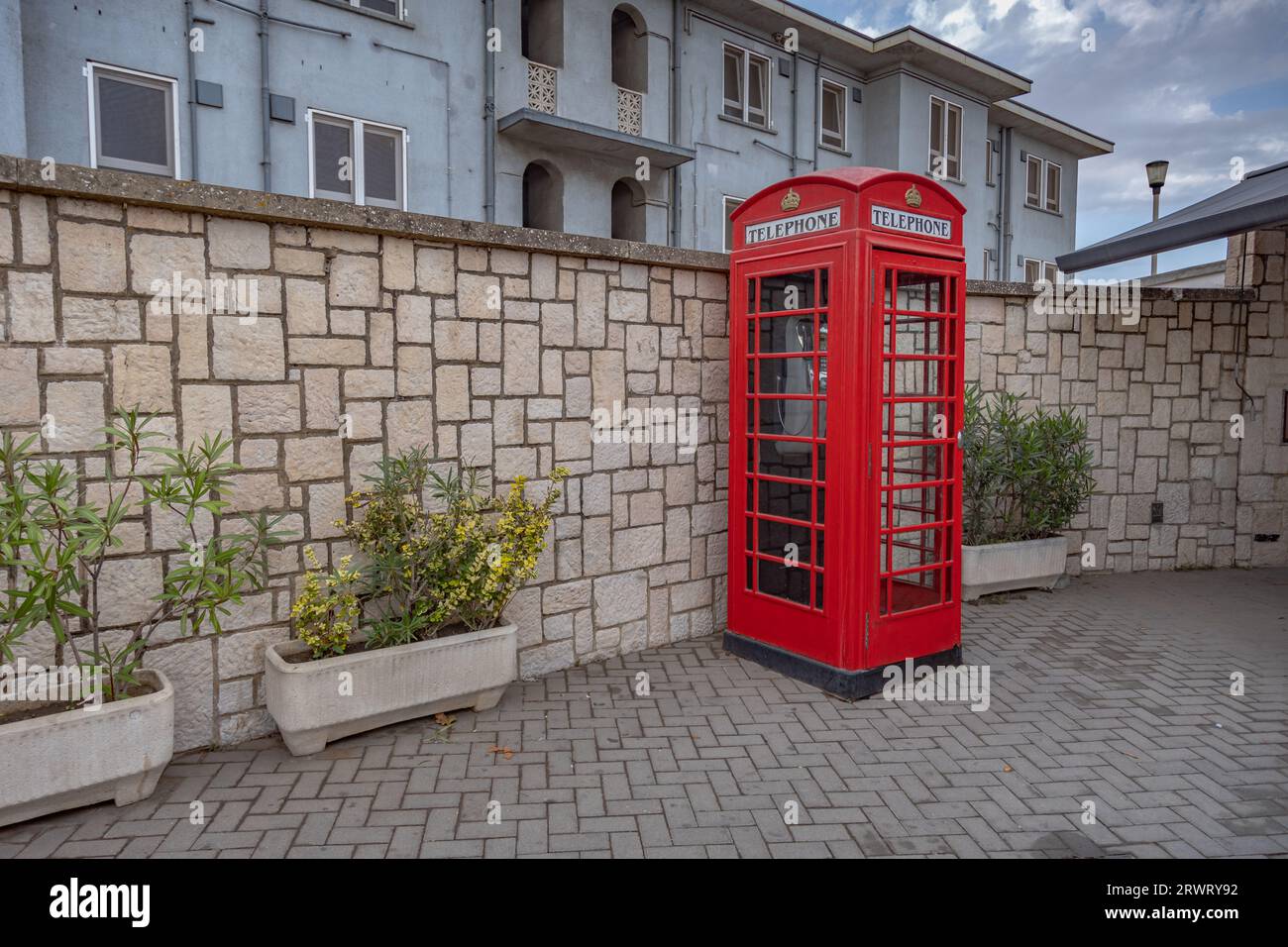 Gibraltar cityscape. Close up of empty typical English red telephone ...