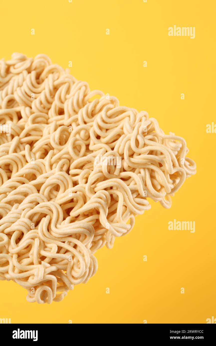 Dry ramen instant noodles with yellow background Stock Photo - Alamy