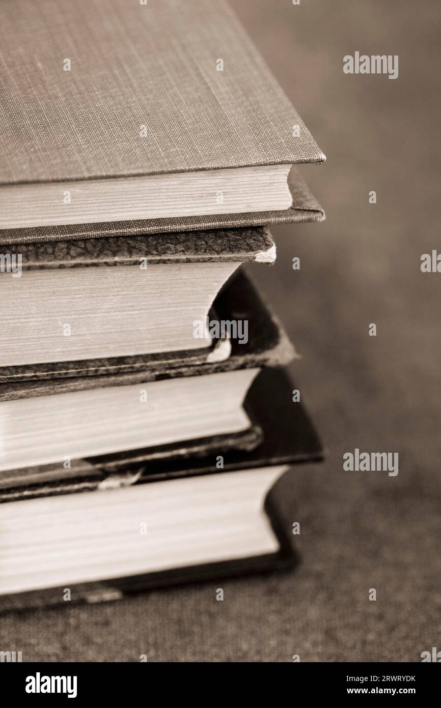 A Sepia toned image of a pile of old books Stock Photo - Alamy