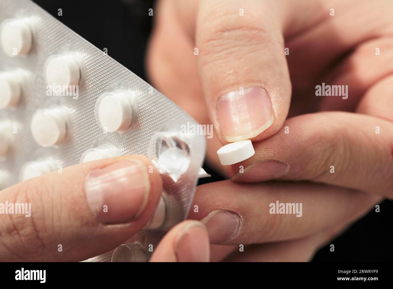 Taking a medicine pill out from a blister pack Stock Photo - Alamy
