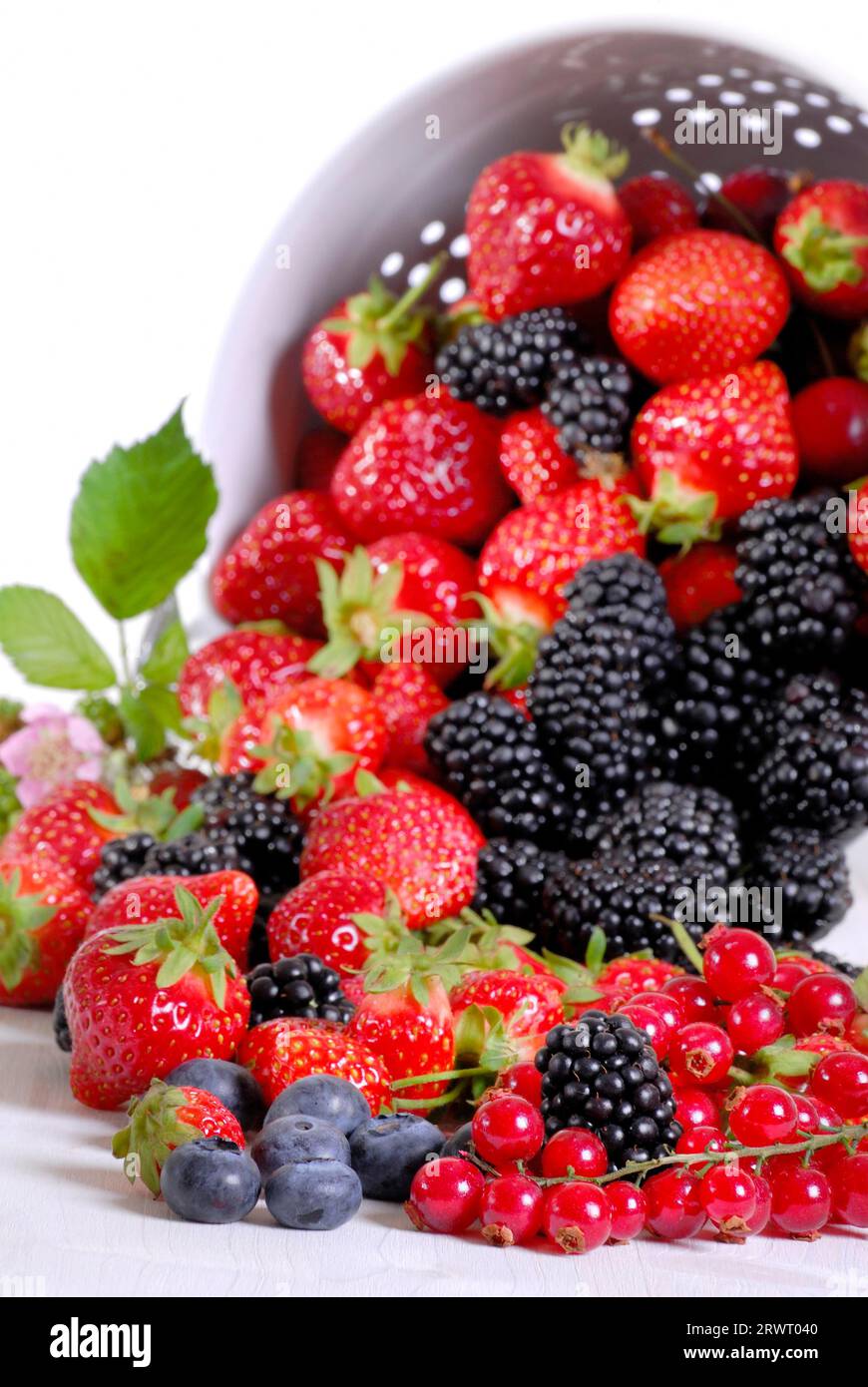Berry mixture with kitchen sieve Stock Photo - Alamy