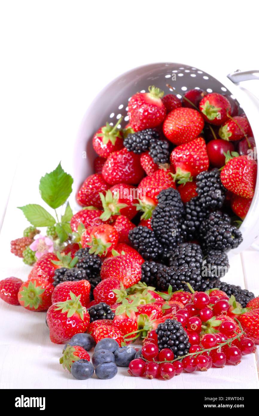 Berry mixture with kitchen sieve Stock Photo - Alamy