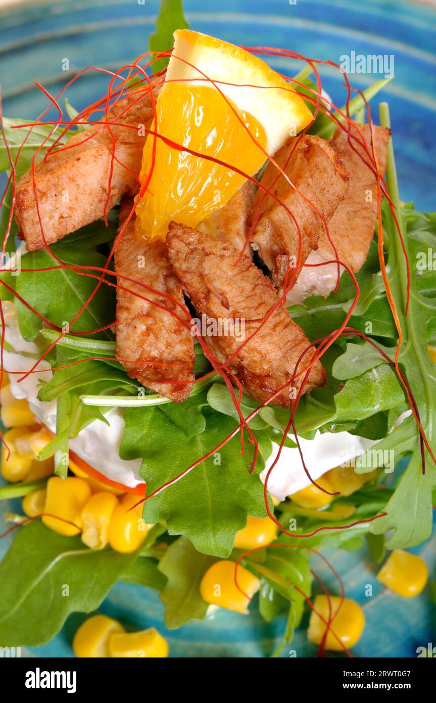 Chicken strips on rocket Stock Photo - Alamy