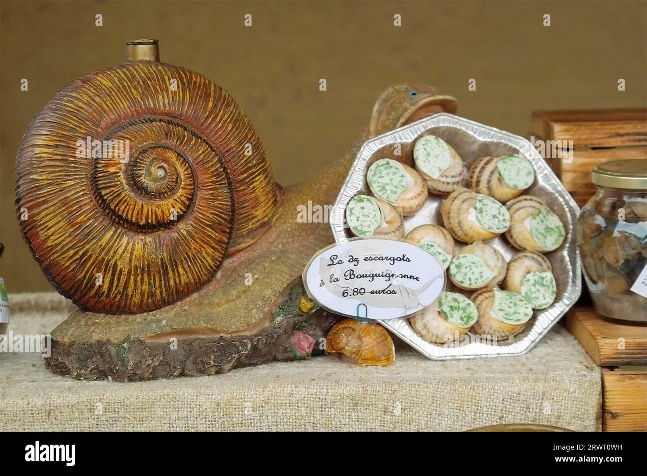 Vineyard snails in packaging with large wooden model of a snail Stock ...
