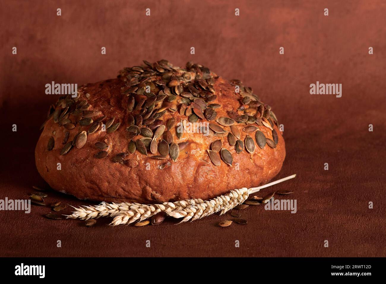 Round pumpkin seed bread decorated with wheat ears Stock Photo - Alamy