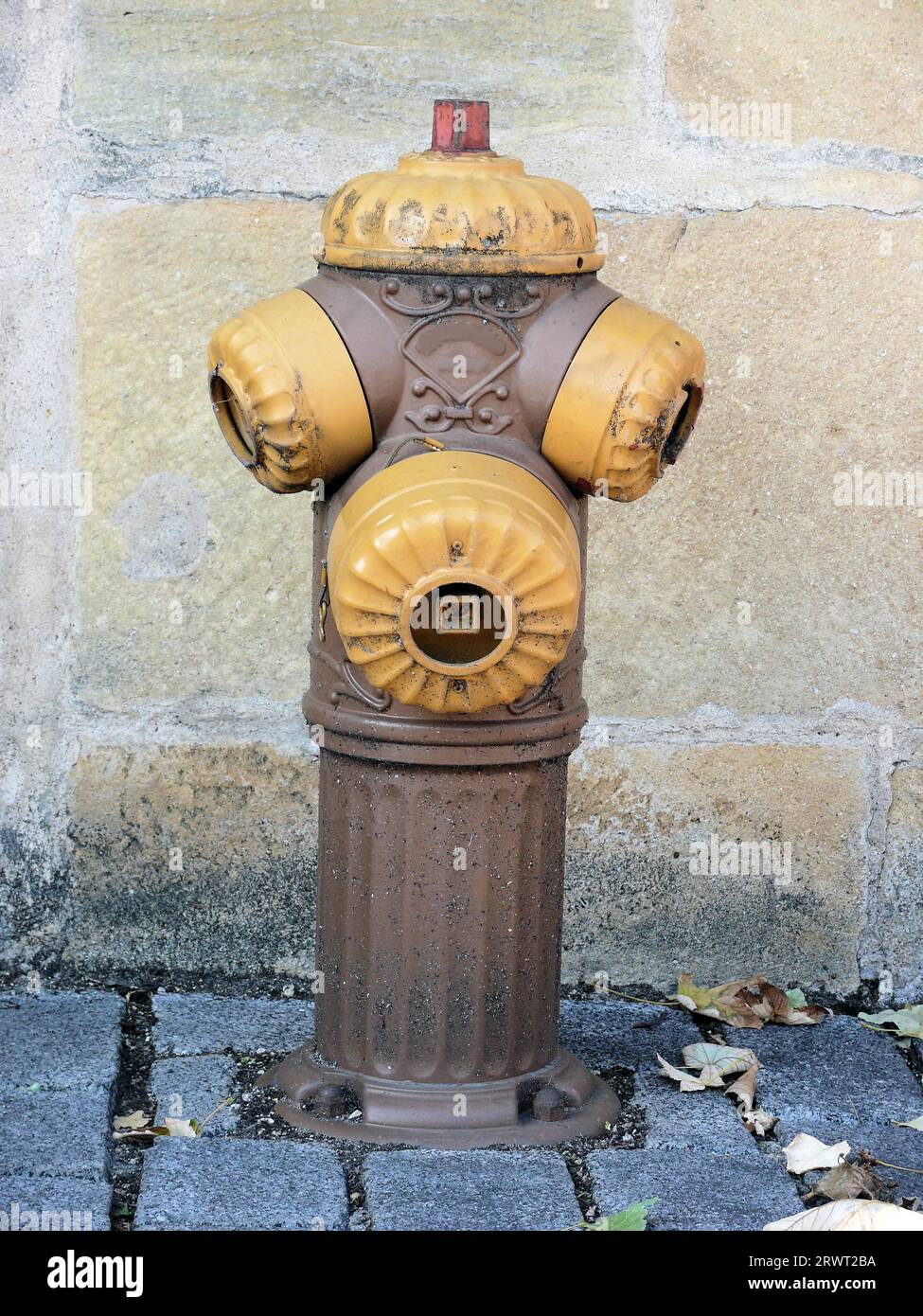 A jewel of a yellow-brown hydrant Stock Photo - Alamy
